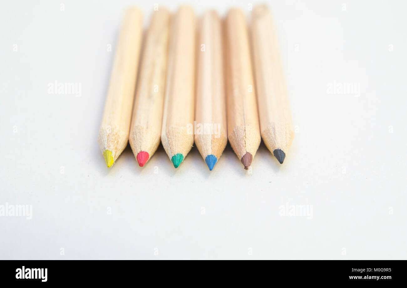 Six wood colored crayons on white background Stock Photo - Alamy