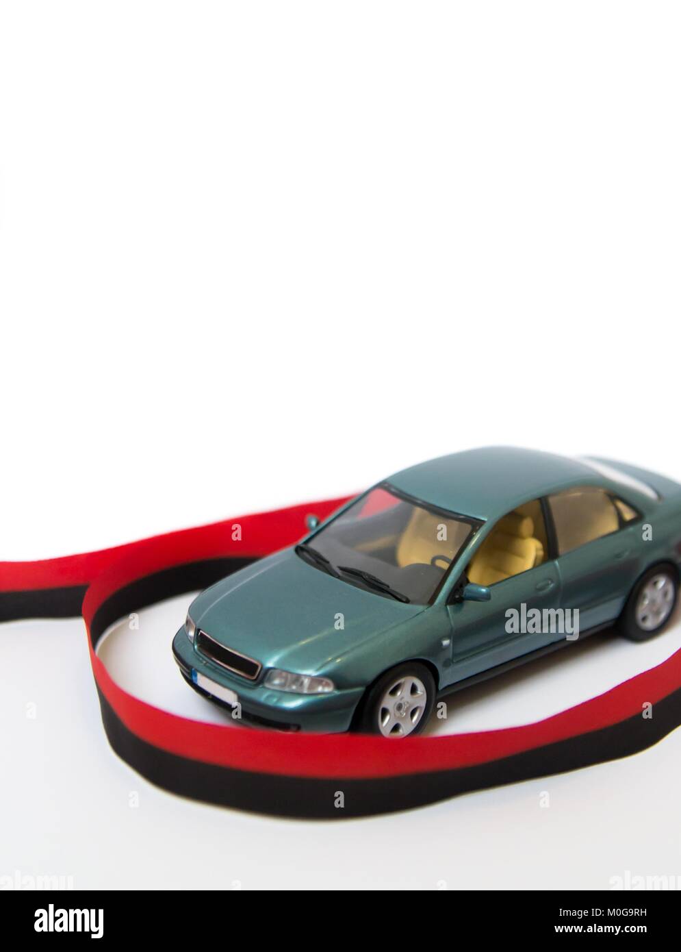 A light blue car surrounded by red an black ribbon, on white Stock ...