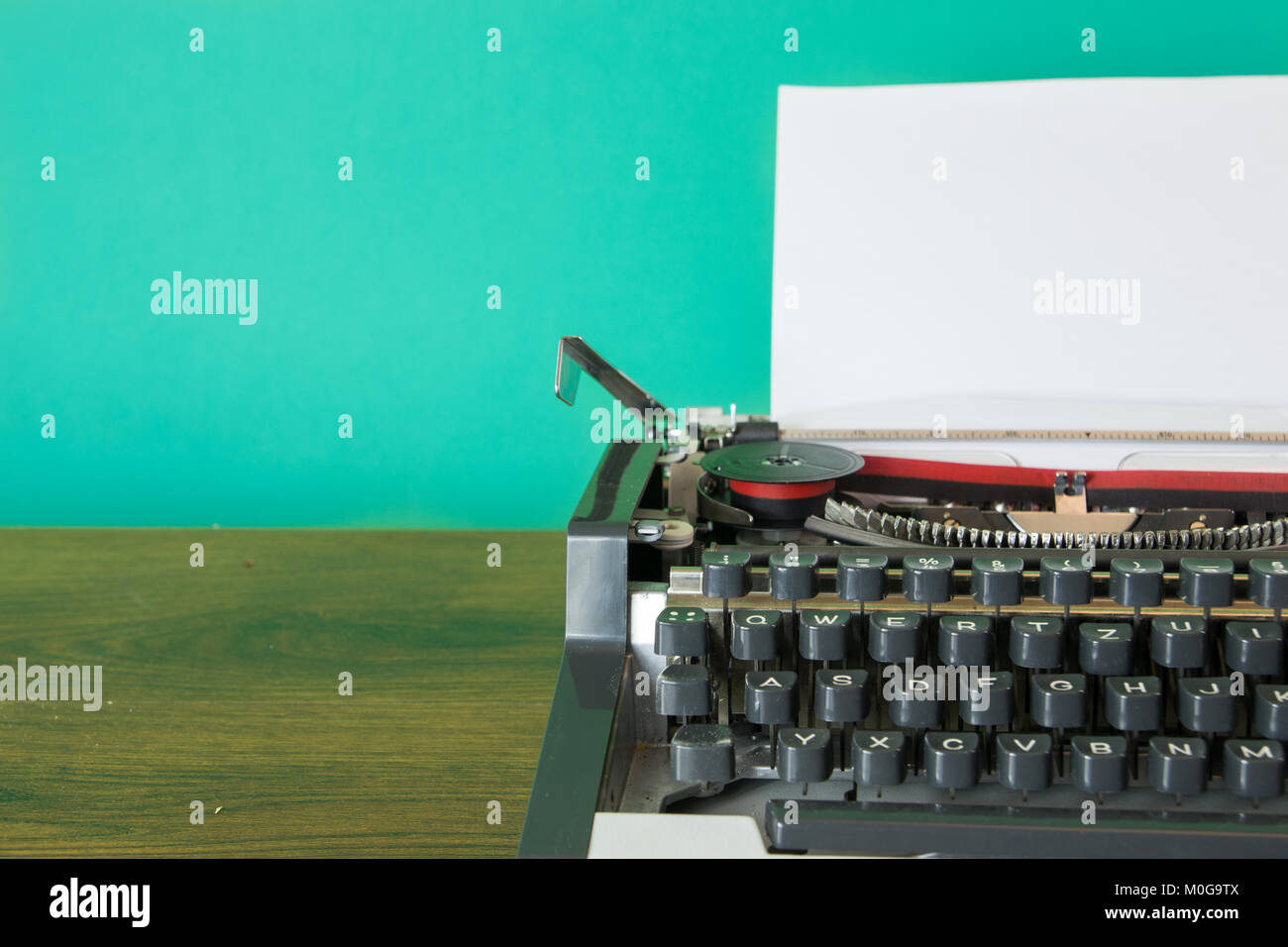 Detail of an old retro typewriter and blank paper Stock Photo - Alamy