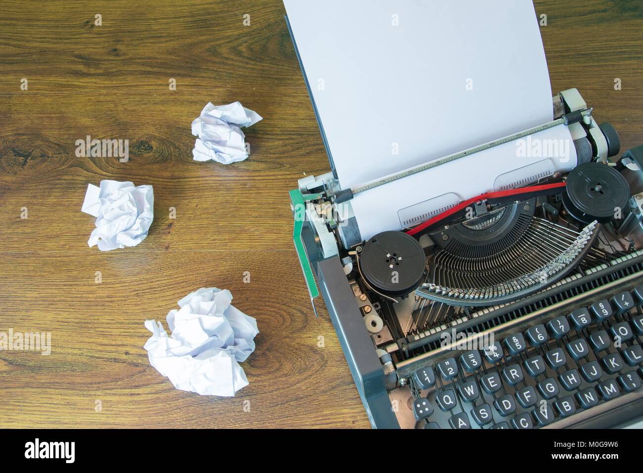 Old typewriter and crumpled paper on wooden desk Stock Photo - Alamy