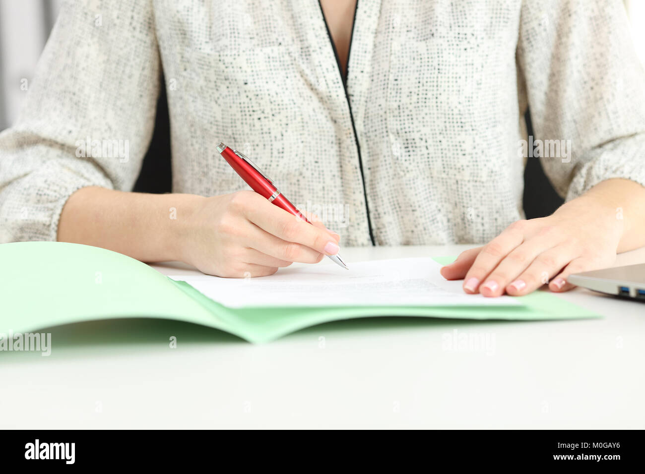 Front view close up portrait of a businesswoman hands signing a ...