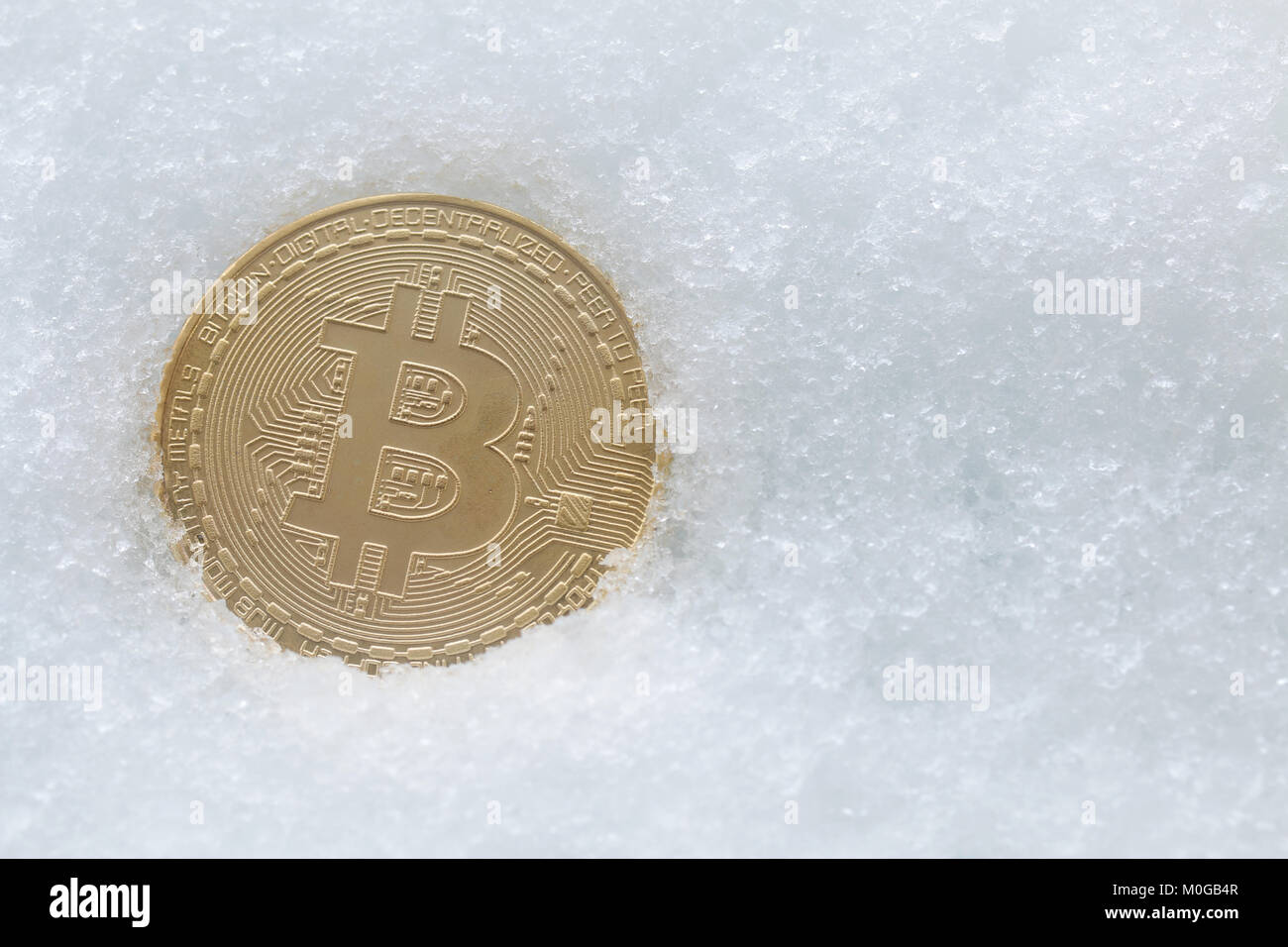 gold bitcoin on cold winter snow background Stock Photo - Alamy