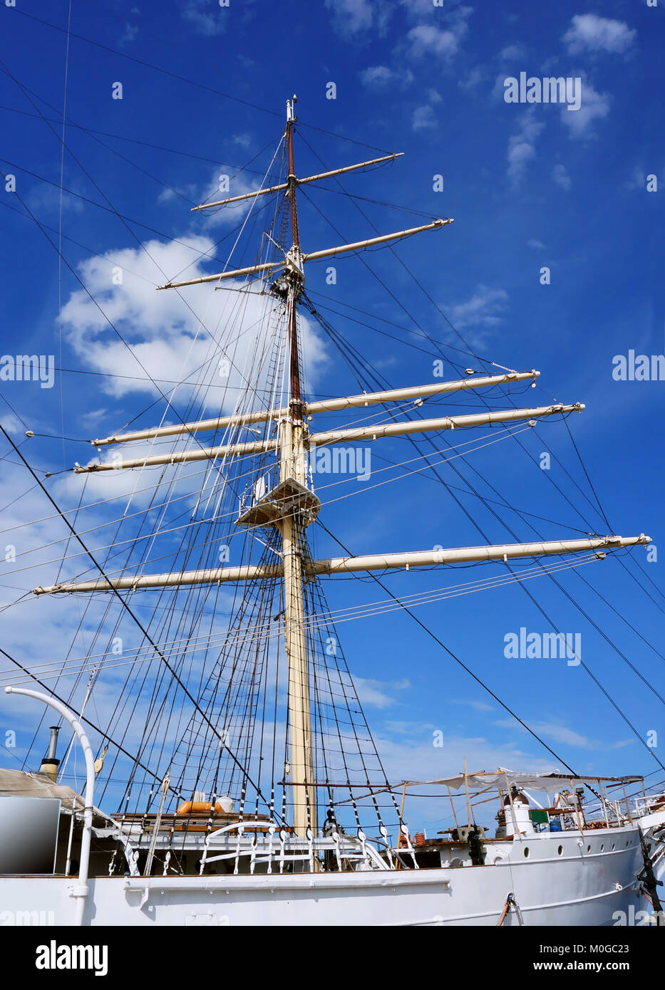 the mast of the ship with lowered sails, the mast of a sailboat against ...