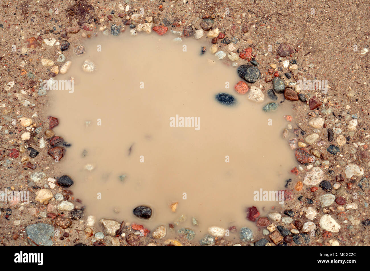 small stones around the puddle in the shape of a heart, the puddle in ...