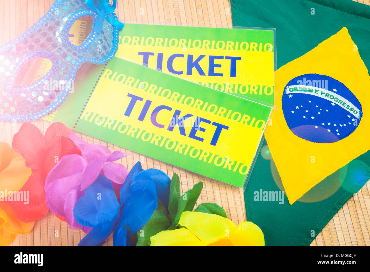 Brazil tickets sitting next to Carnival mask and colorful flower lei on ...