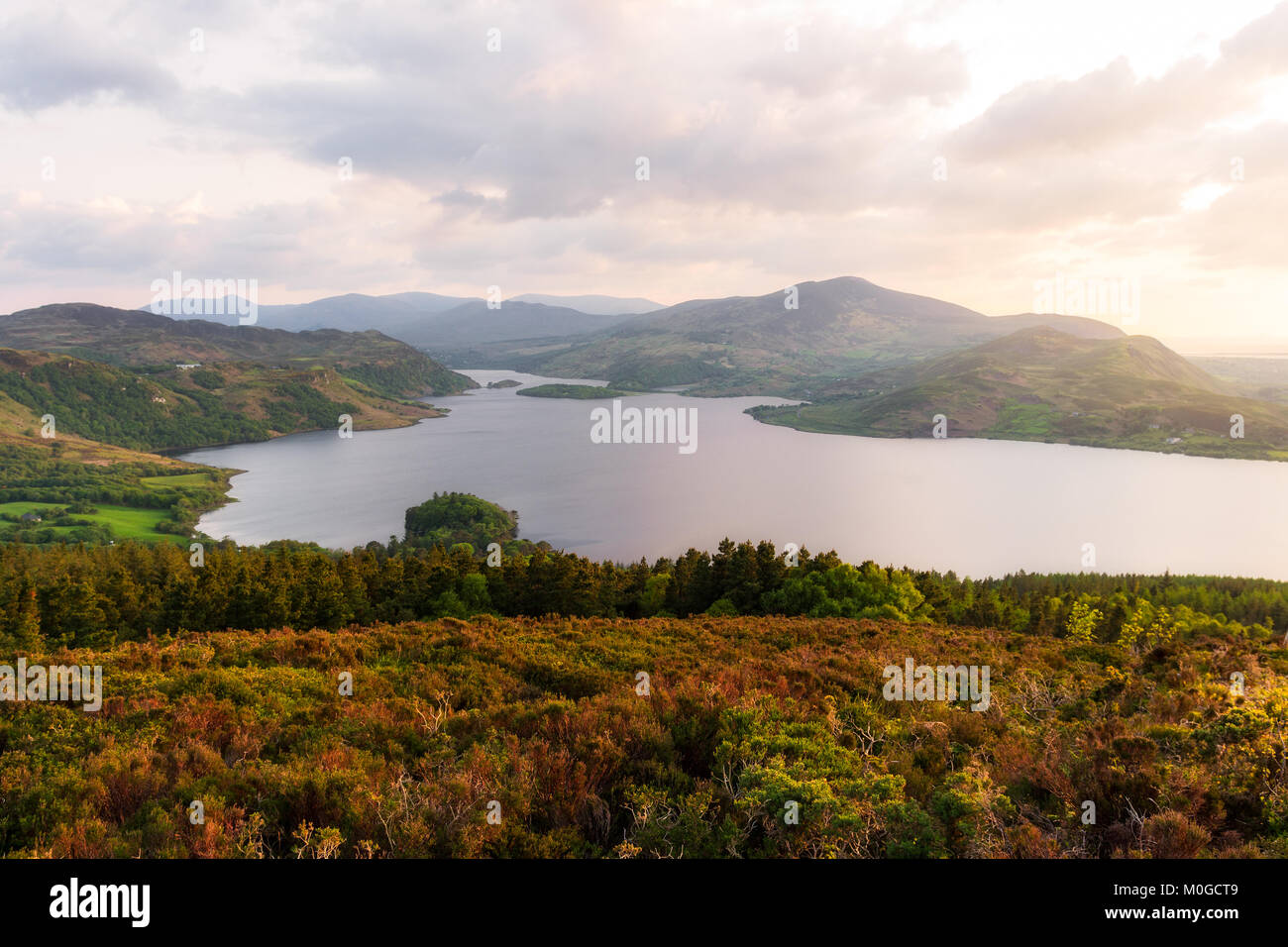 Calm bright evening looking down at Caragh Lake from the hillside Stock ...