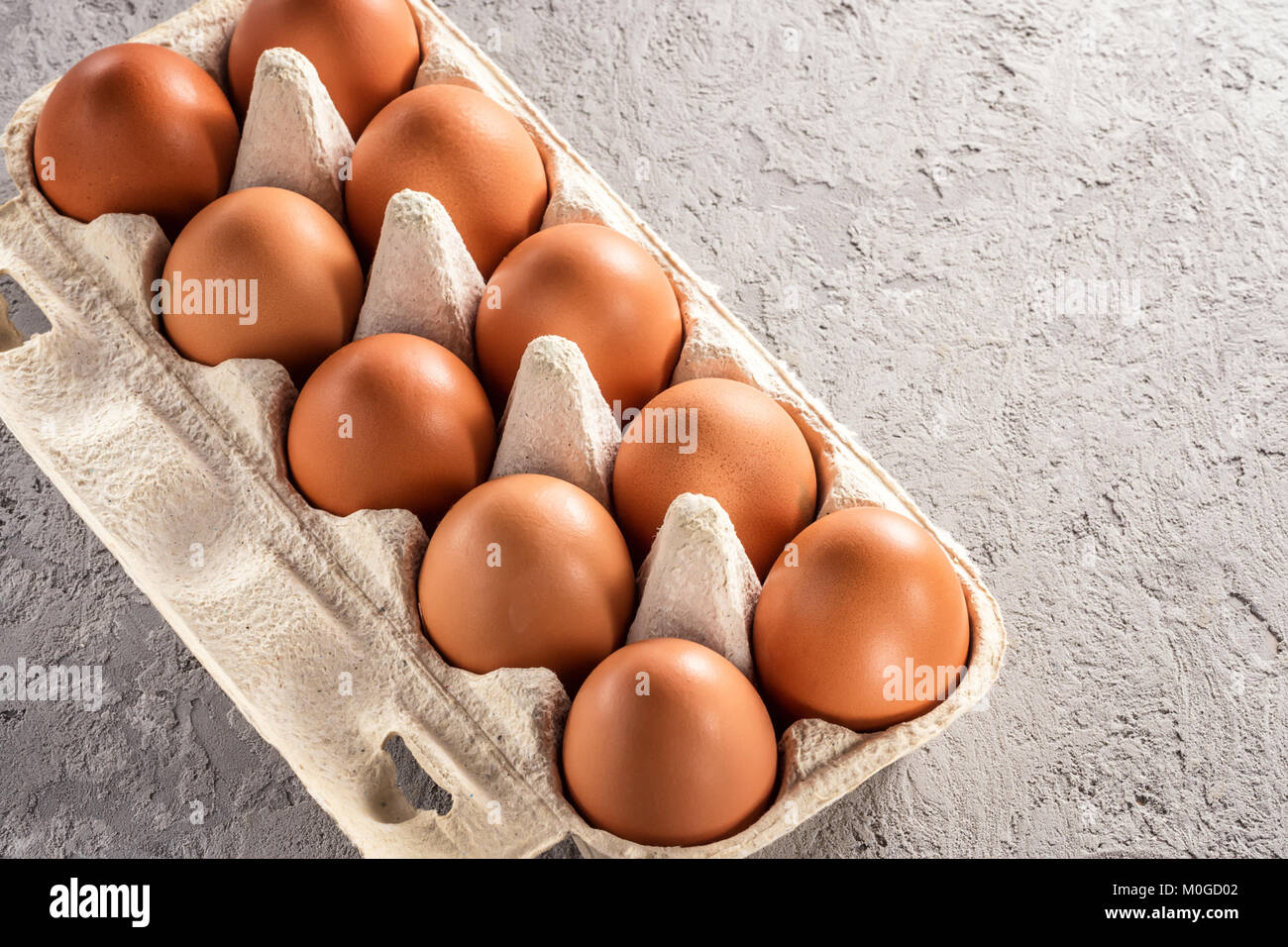 Farm raw fresh egg in pack on gray table scrambled eggs omelet fried ...