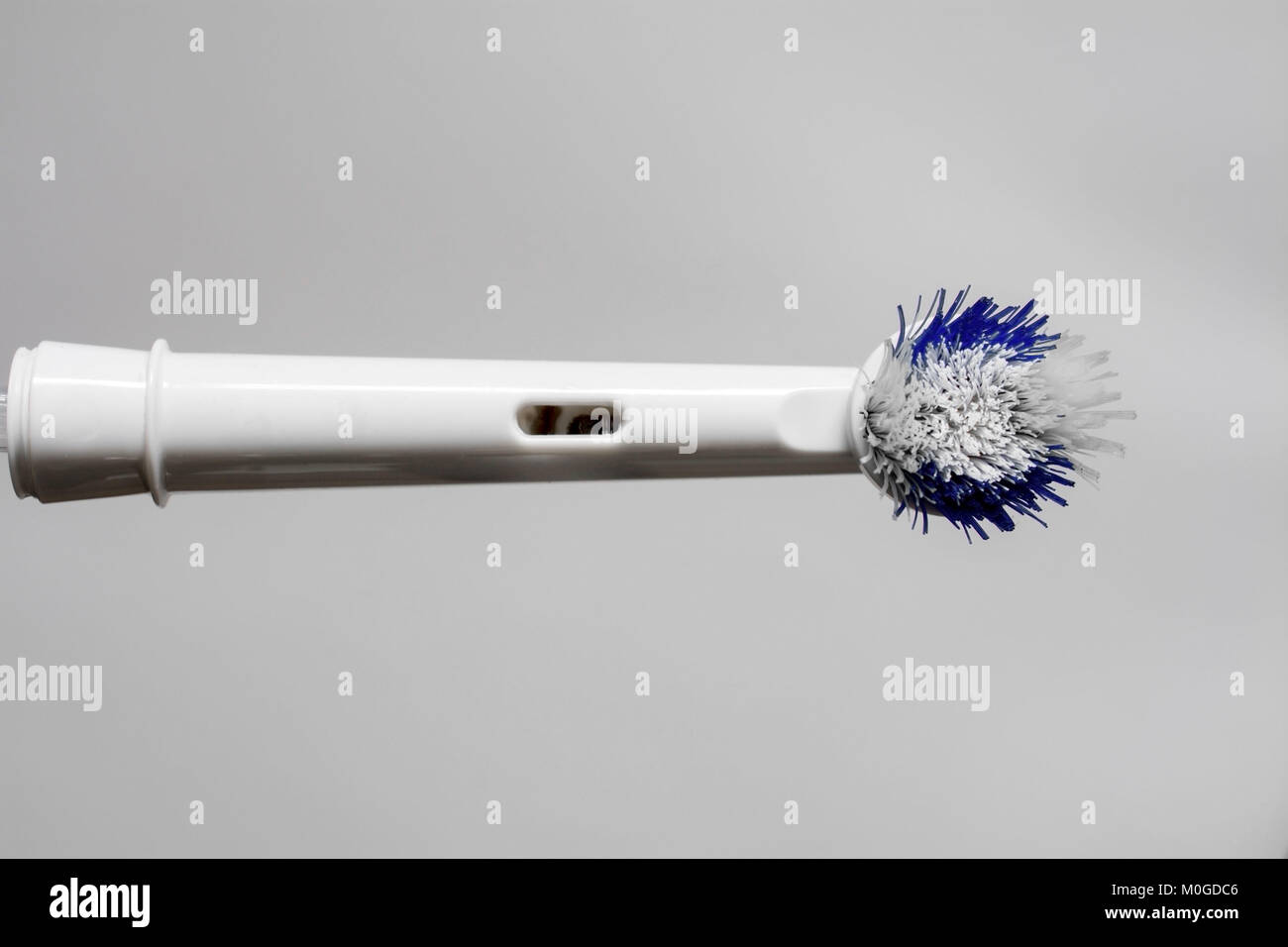 Close-up on the top of the head of a worn out white and blue head of an ...