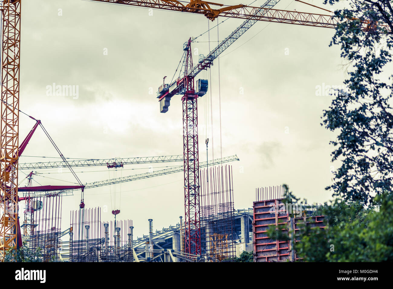 Crains on construction site of building Stock Photo - Alamy