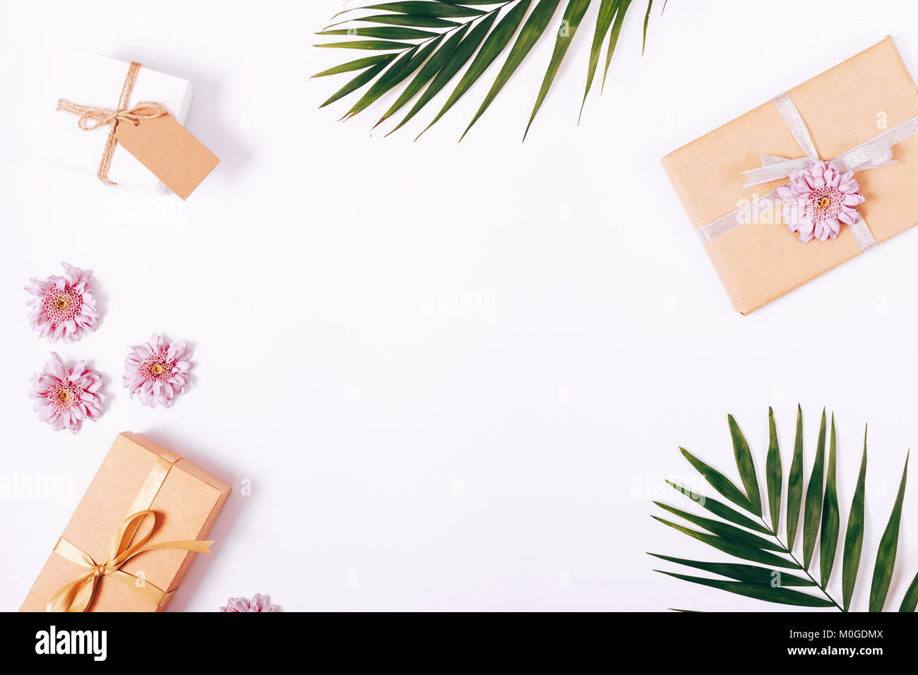 Top view of festive decorations and gift boxes with flowers on white ...