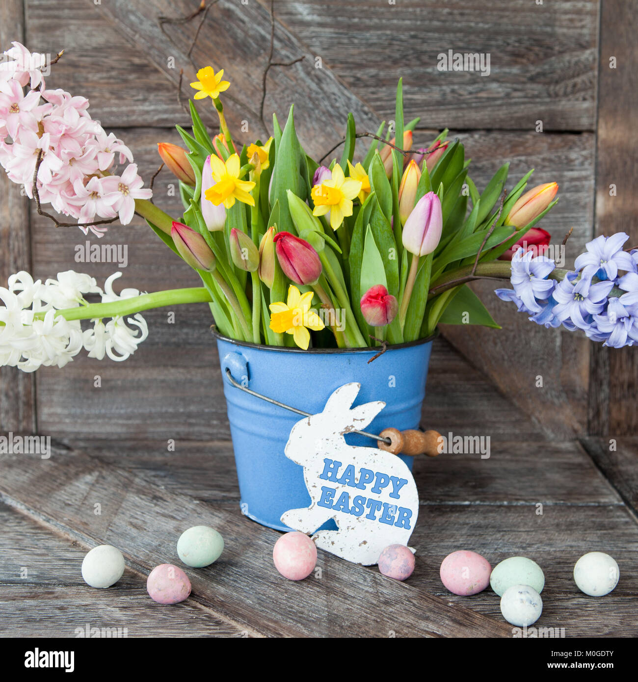 Colorful spring flowers in vintage blue bucket Stock Photo - Alamy