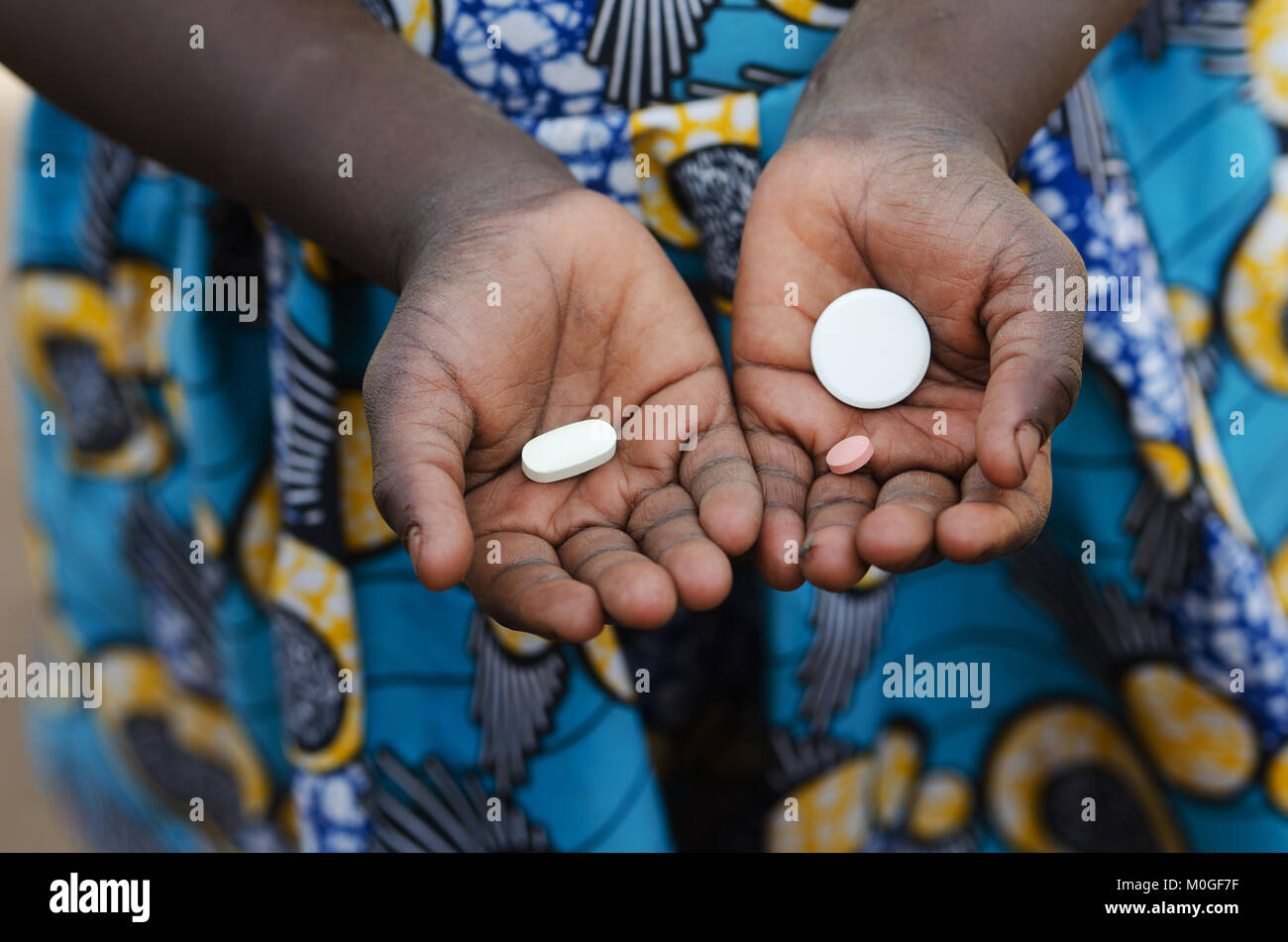 African Black Child Showing Pills as Medicine in Mali Stock Photo - Alamy