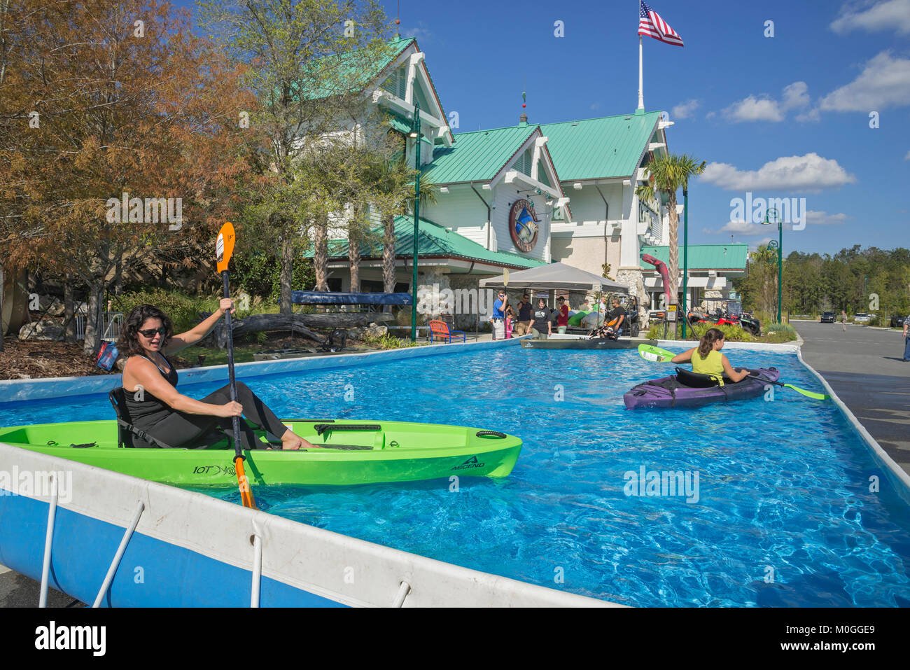 Trying out the kayaks in a temporary pool at a Bass Pro Shops store in ...