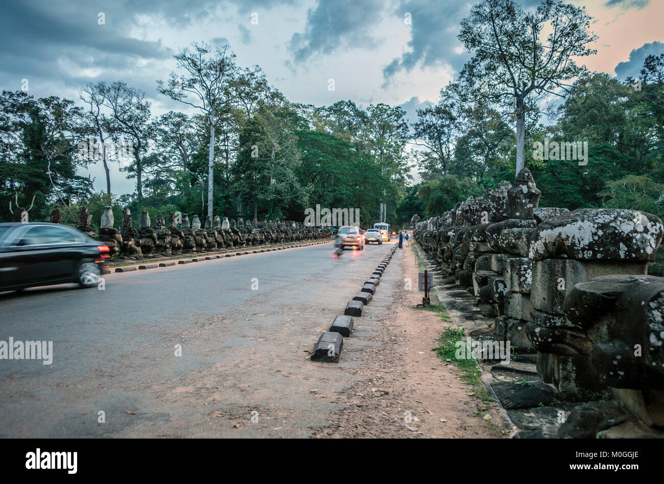 Tourists and traffic on bridge at South gate, Bayon Temple, Angkor Thom ...