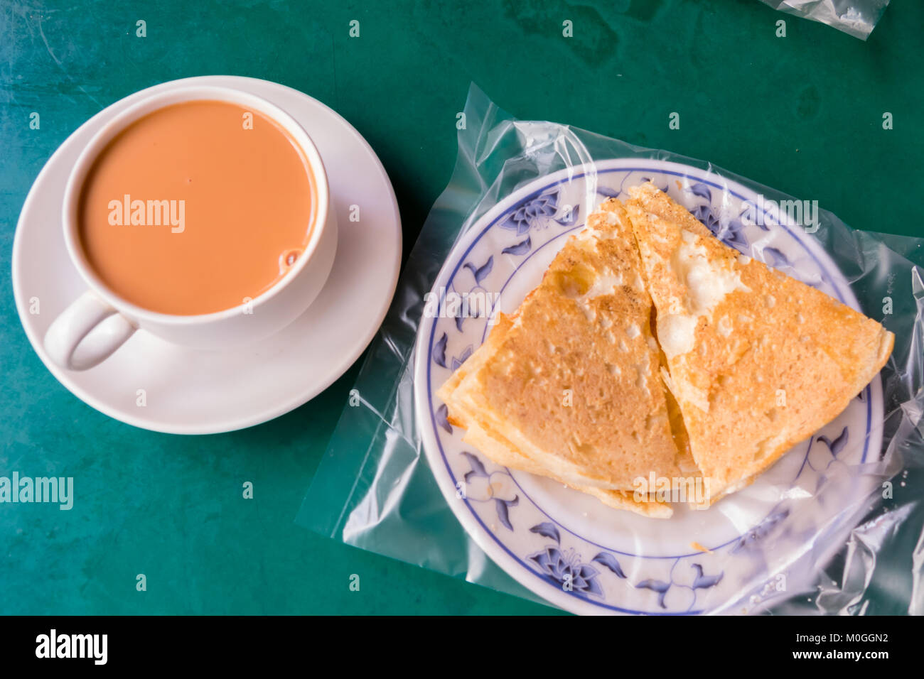 Burmese milk tea and sweet dessert na'an served on table Stock Photo ...