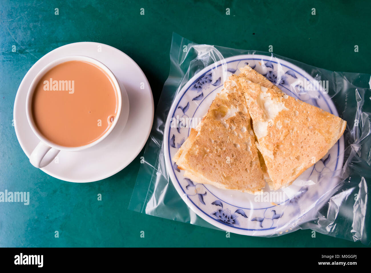 Burmese milk tea and sweet dessert na'an served on table Stock Photo ...