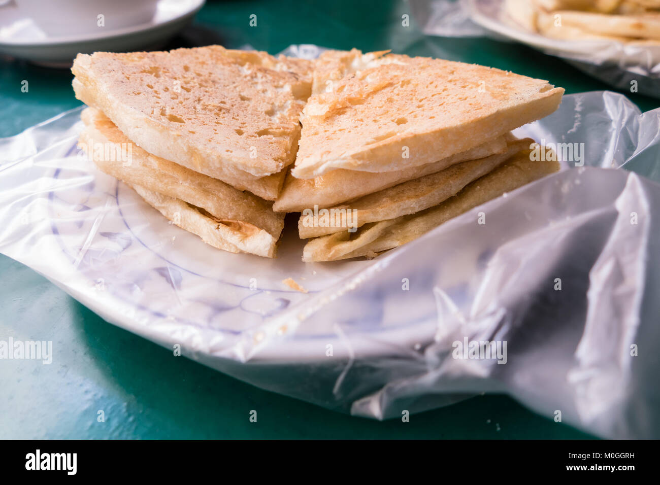 Burmese sweet roti na'an served on table Stock Photo - Alamy