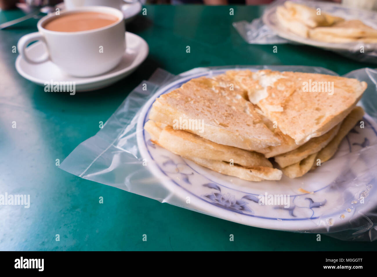 Burmese milk tea and sweet na'an served on table Stock Photo - Alamy