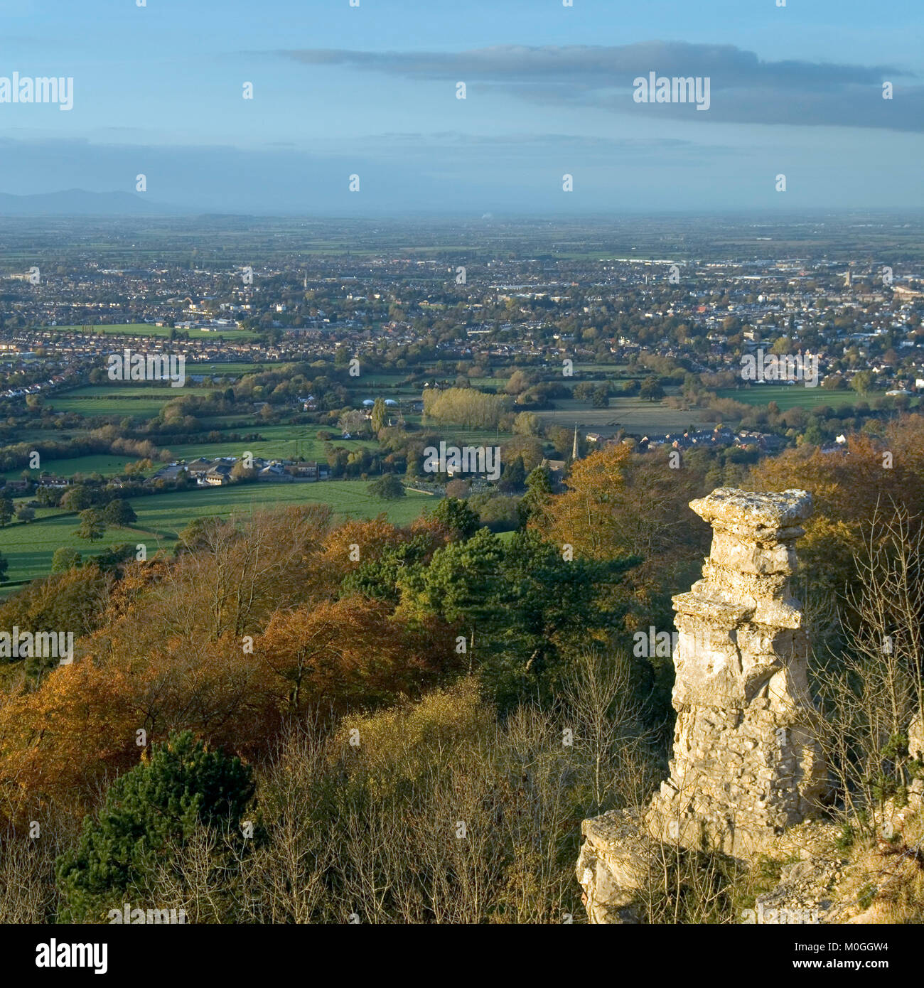 The Devils Chimney glowing in evening sun, Leckhampton Hill, Cotswolds ...