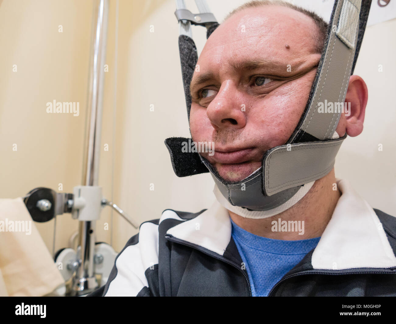 Man in neck traction machine for physiotherapy Stock Photo - Alamy