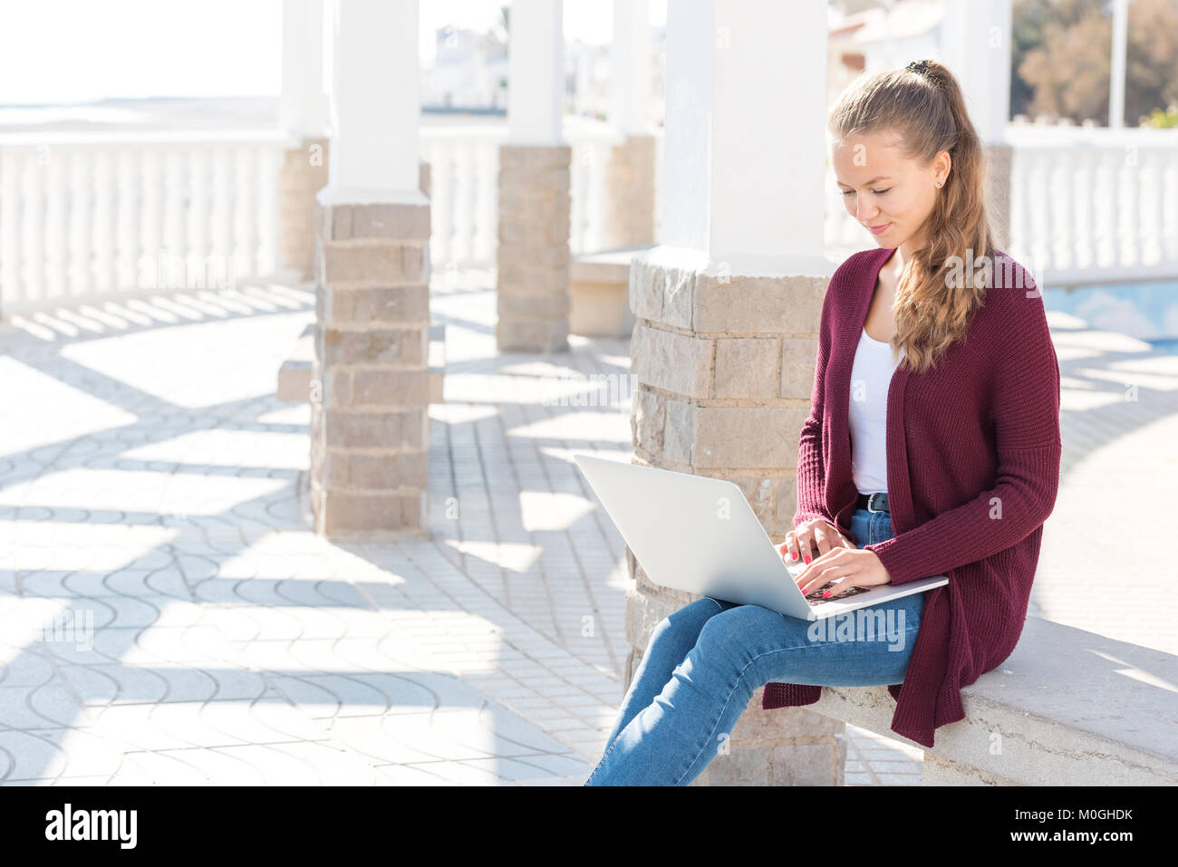 Young girl working on laptop outdoor Stock Photo - Alamy