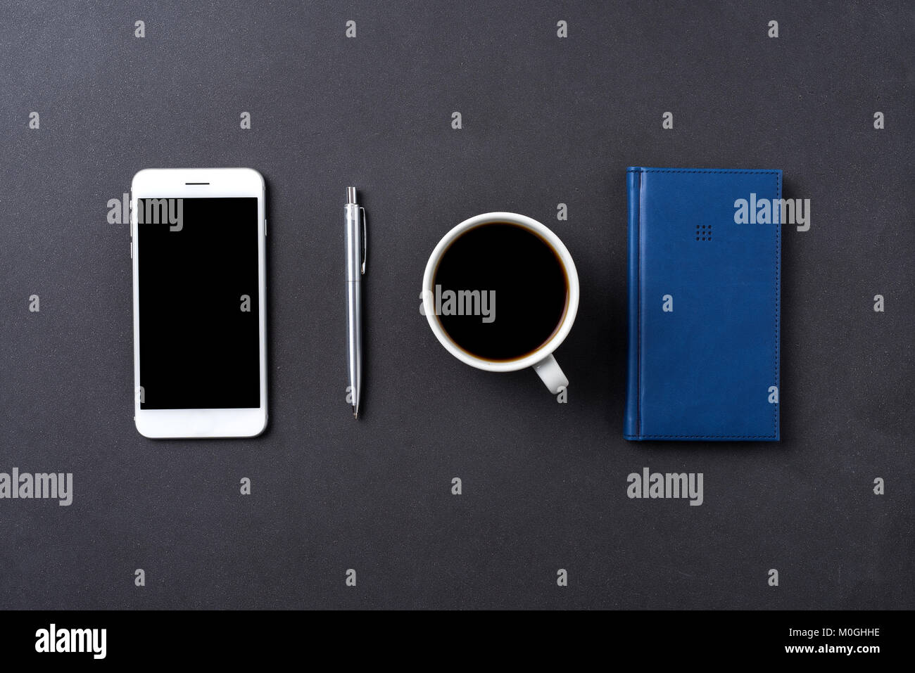 Office desktop with pen, smart phone and notebook Stock Photo - Alamy