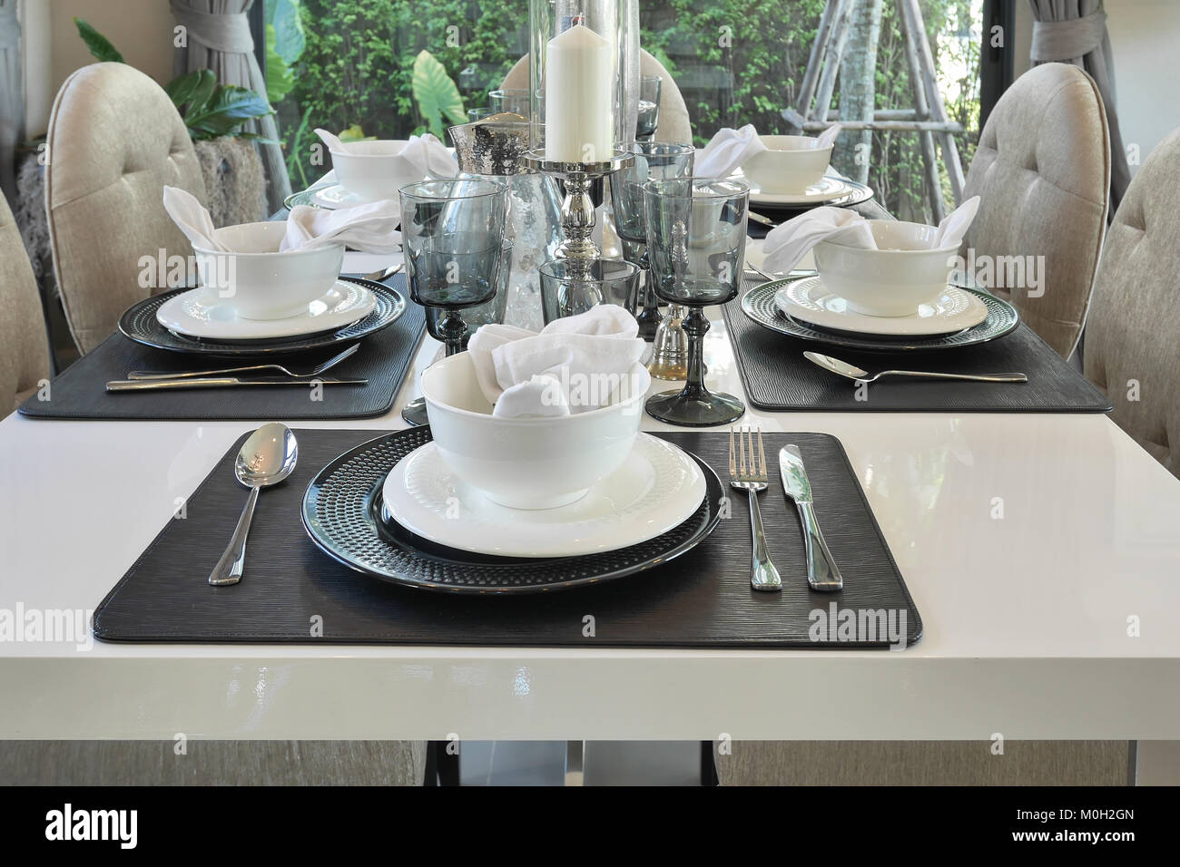 elegant table set on dining table in modern style dining room interior ...