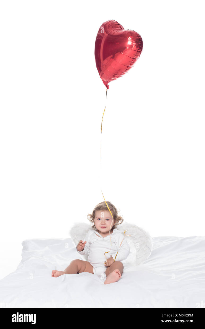 baby angel with wings and nimbus holding heart balloon, isolated on ...