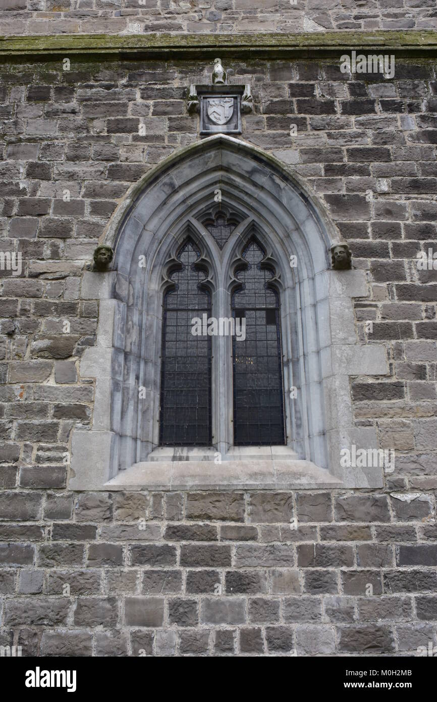 Arched gothic double church window with multiple glass panes in stone ...