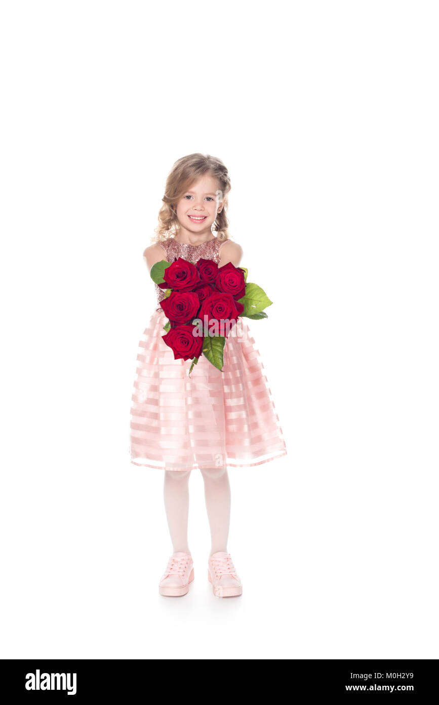 adorable child in dress holding bouquet of red roses, isolated on white ...