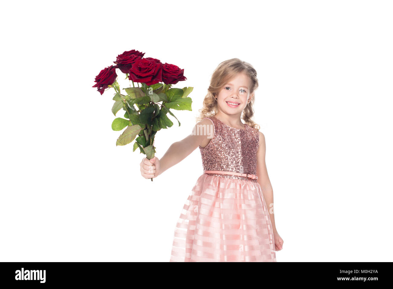 adorable smiling kid in dress holding bouquet of red roses, isolated on ...