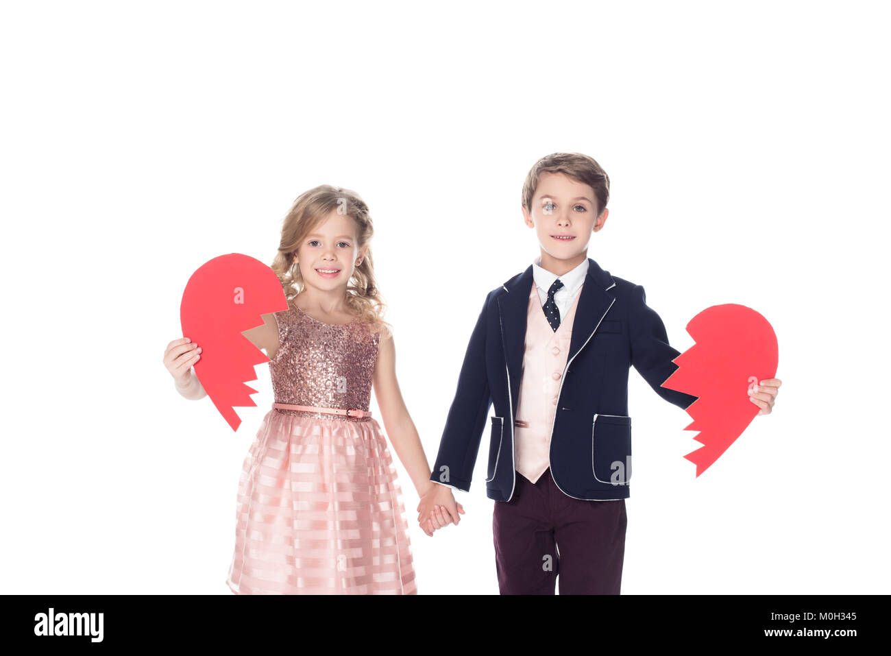 cute little kids holding pieces of broken heart symbol and smiling at ...