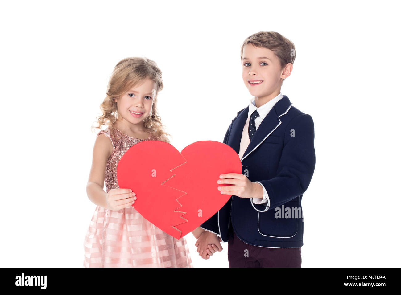 cute little kids holding broken heart symbol and smiling at camera ...