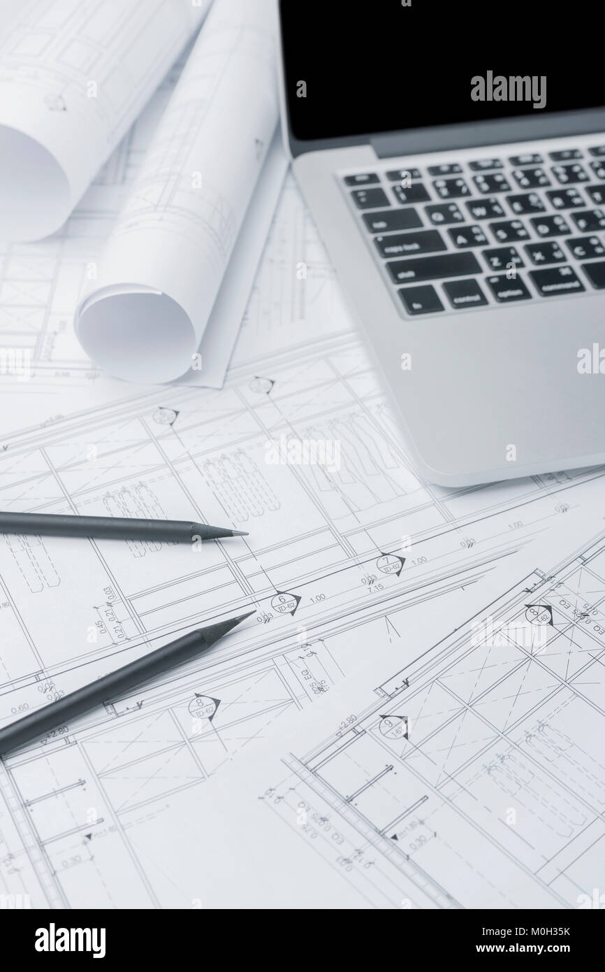 black pencil and computer laptop on architectural drawing paper for ...