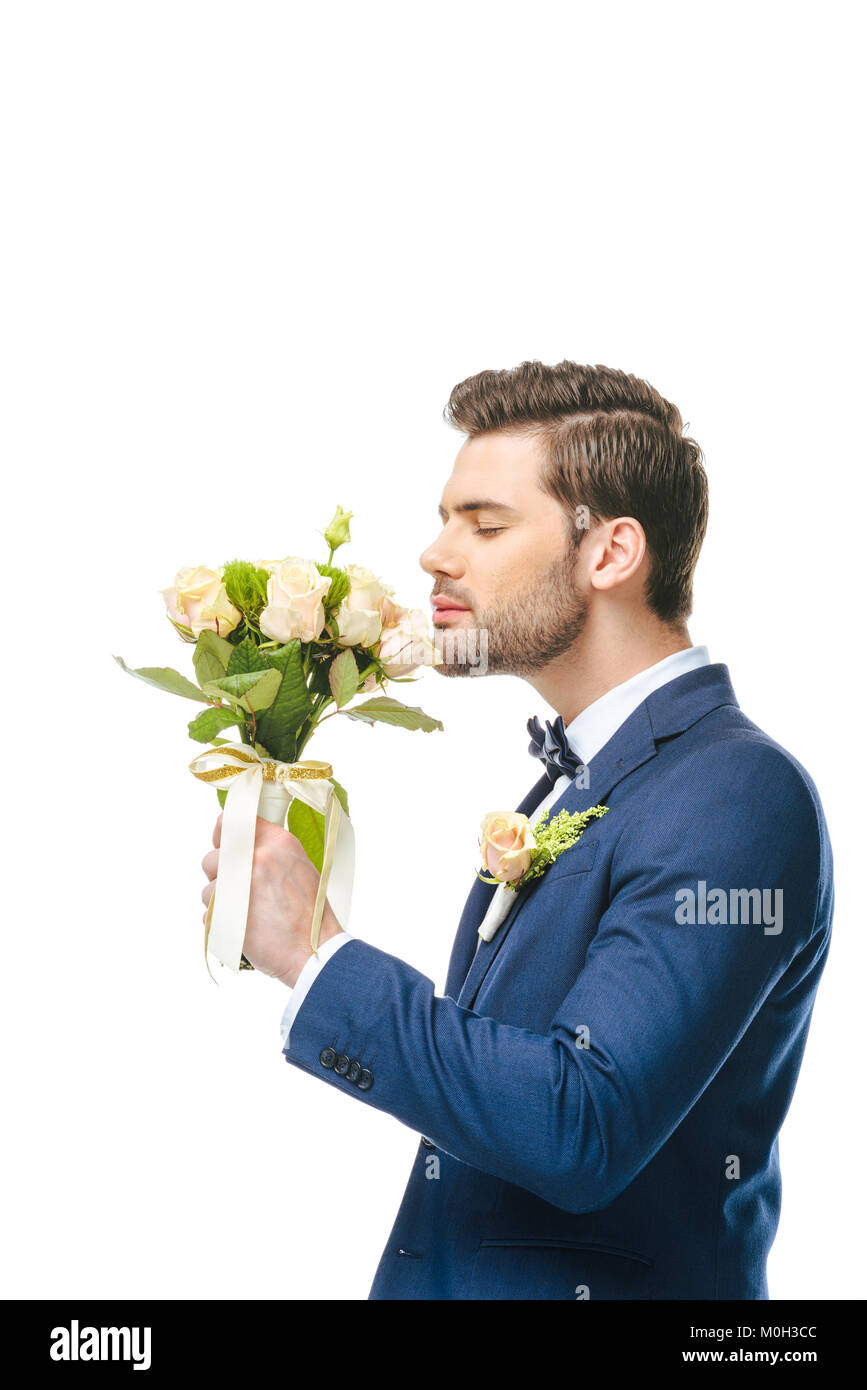 side view of groom with wedding bouquet in hand isolated on white Stock ...
