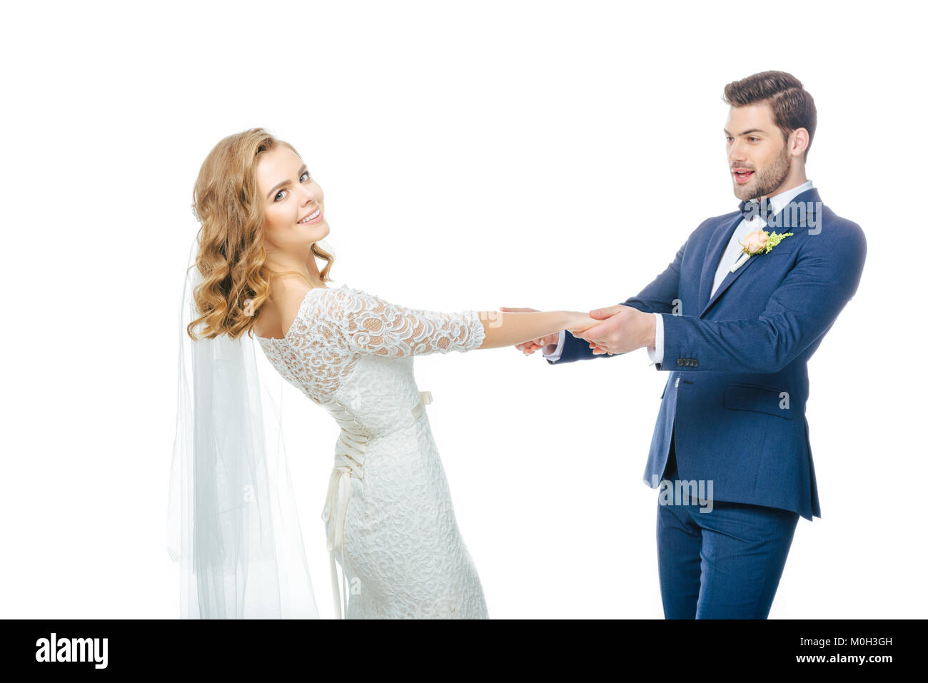 beautiful wedding couple holding hands while dancing together isolated ...