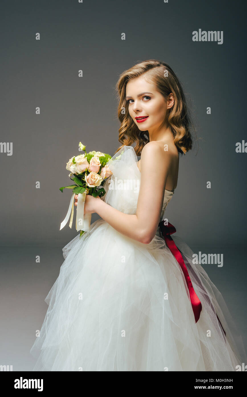 side view of bride in wedding dress with bouquet of flowers Stock Photo ...