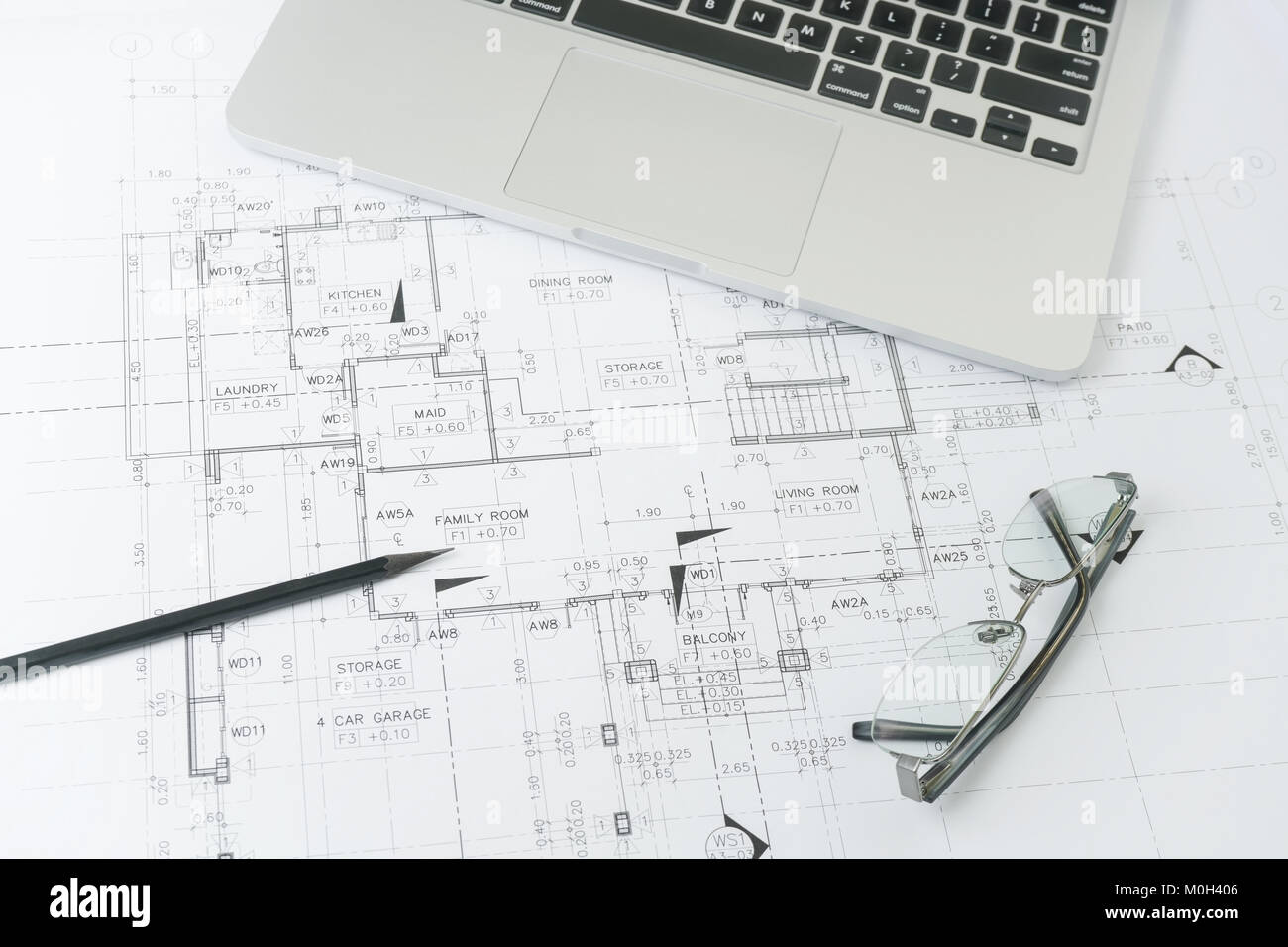 black pencil and computer laptop on architectural drawing paper for ...