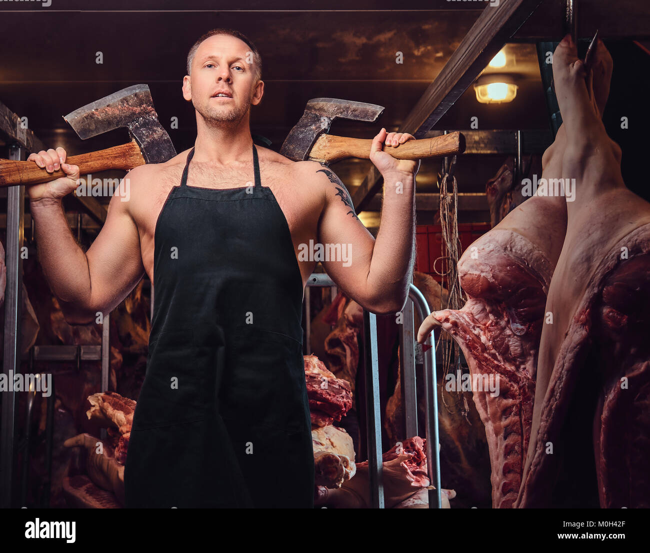 A butcher holds an ax in a meat factory Stock Photo - Alamy