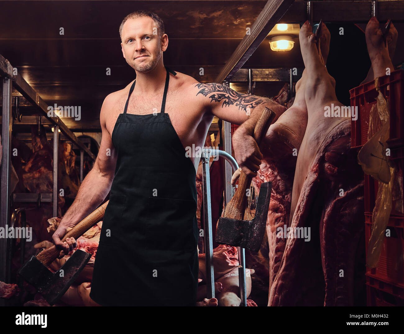 A butcher holds an ax in a meat factory Stock Photo - Alamy