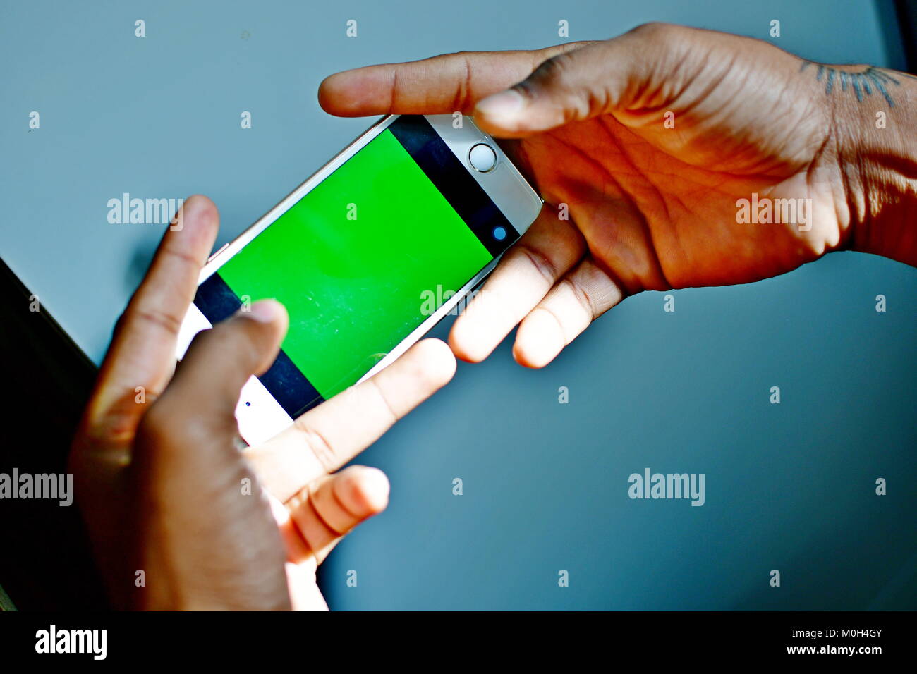 Green screen ready android and man viewing against striped window of ...