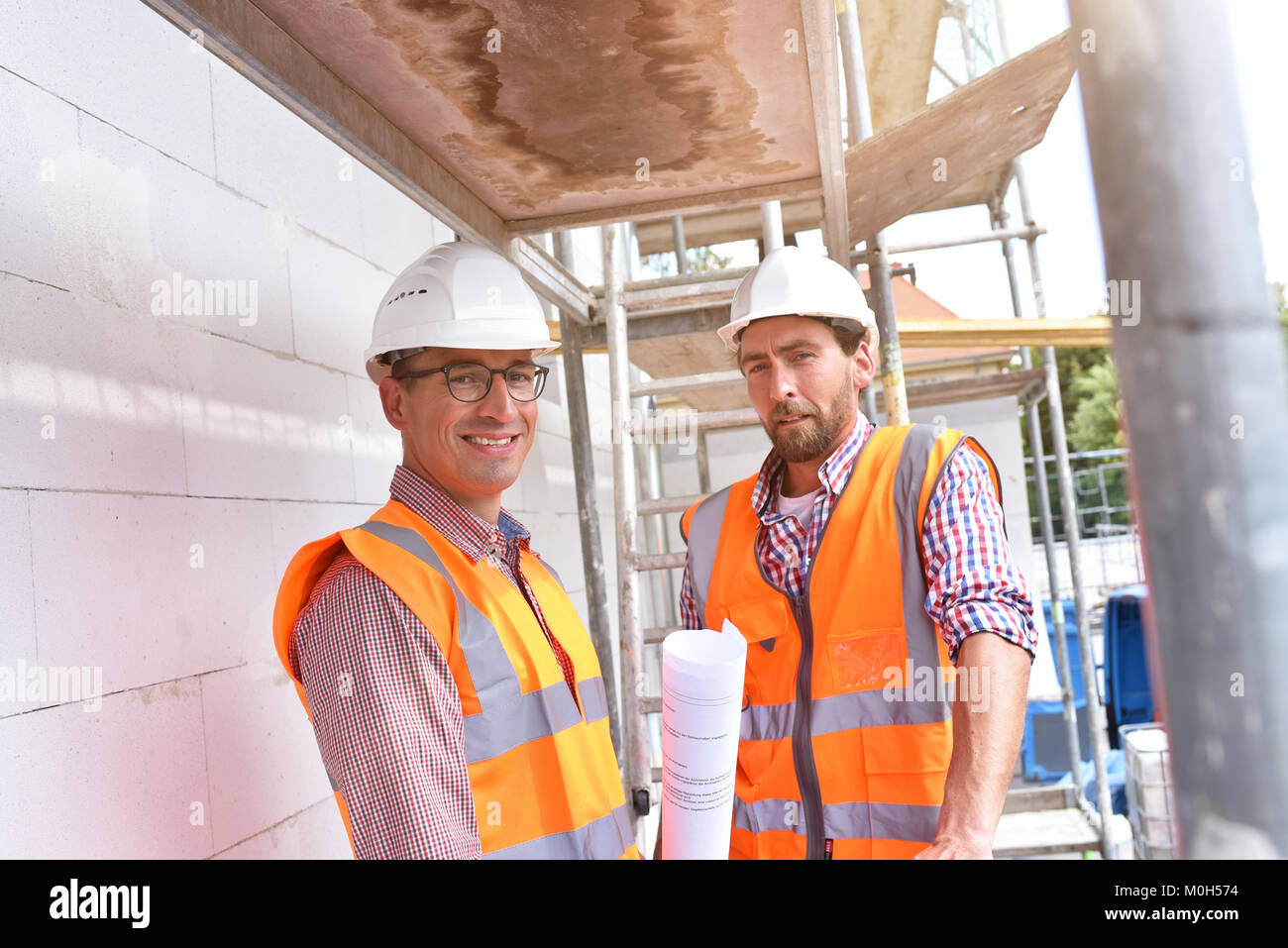 teamwork on the construction site - site manager and architect on site ...