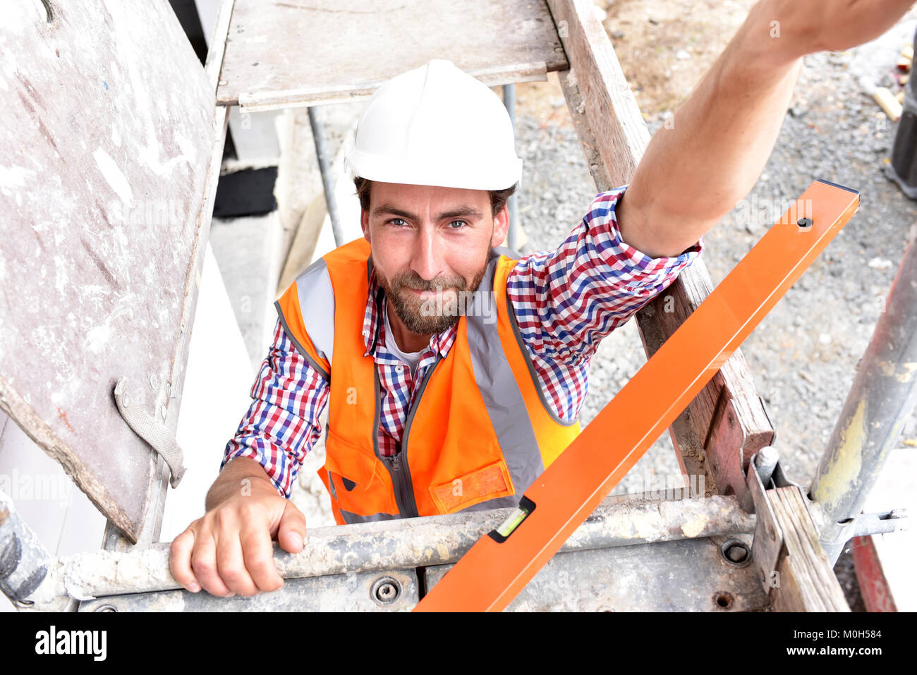 portrait smiling construction manager / architect on site during the ...