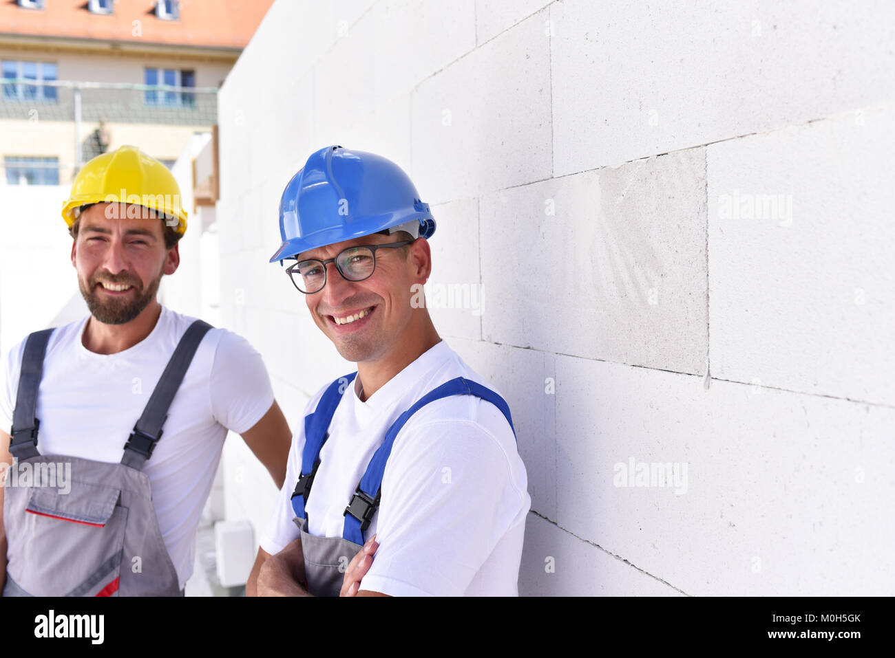 teamwork on the construction site - bricklayer build a family home ...