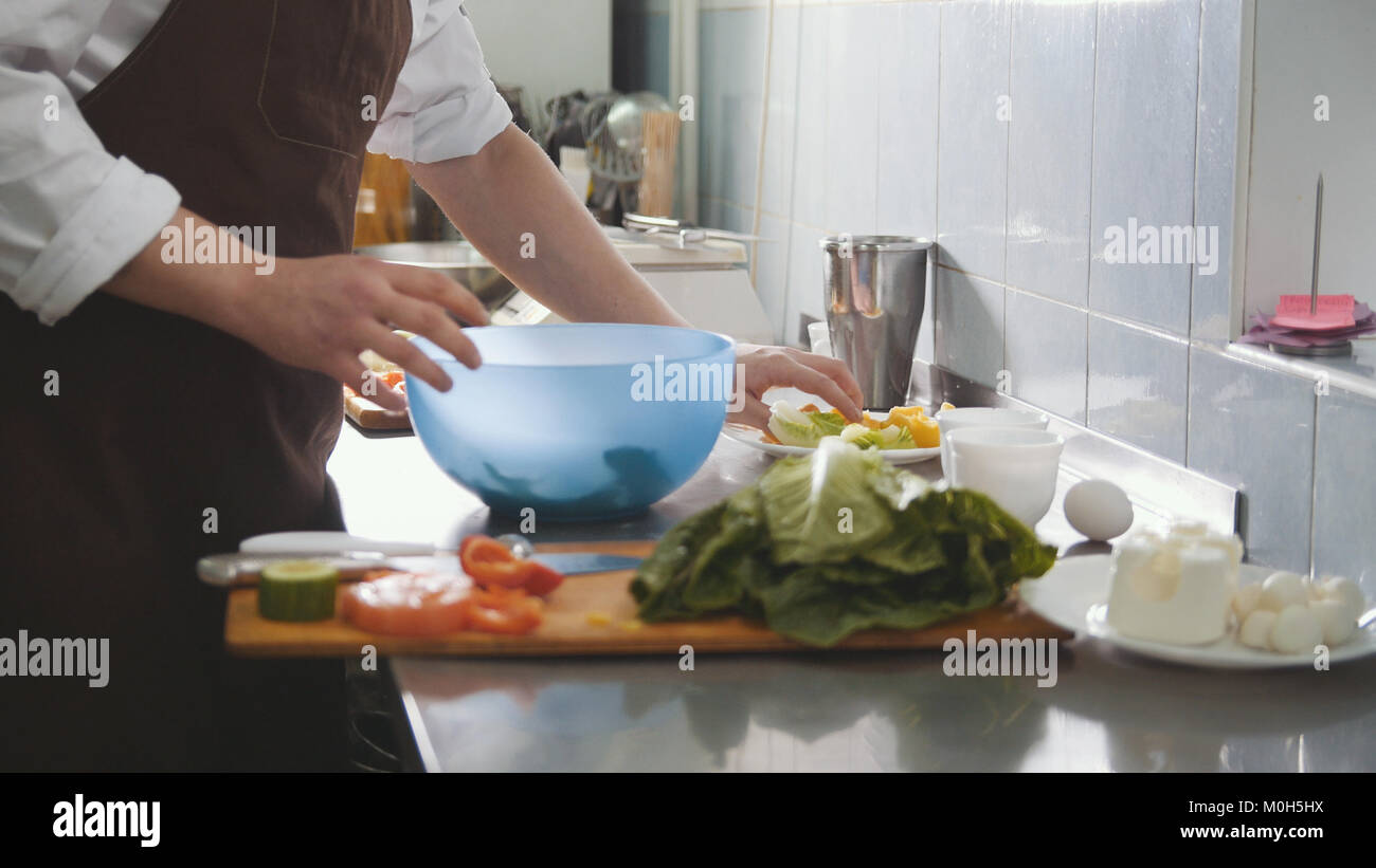 Male chef preparing salad in the kitchen Stock Photo - Alamy