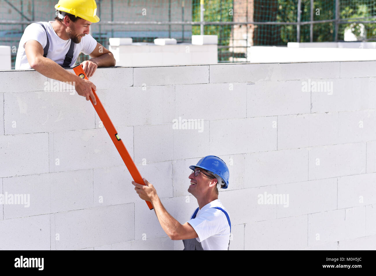 teamwork on the construction site - bricklayer build a family home ...