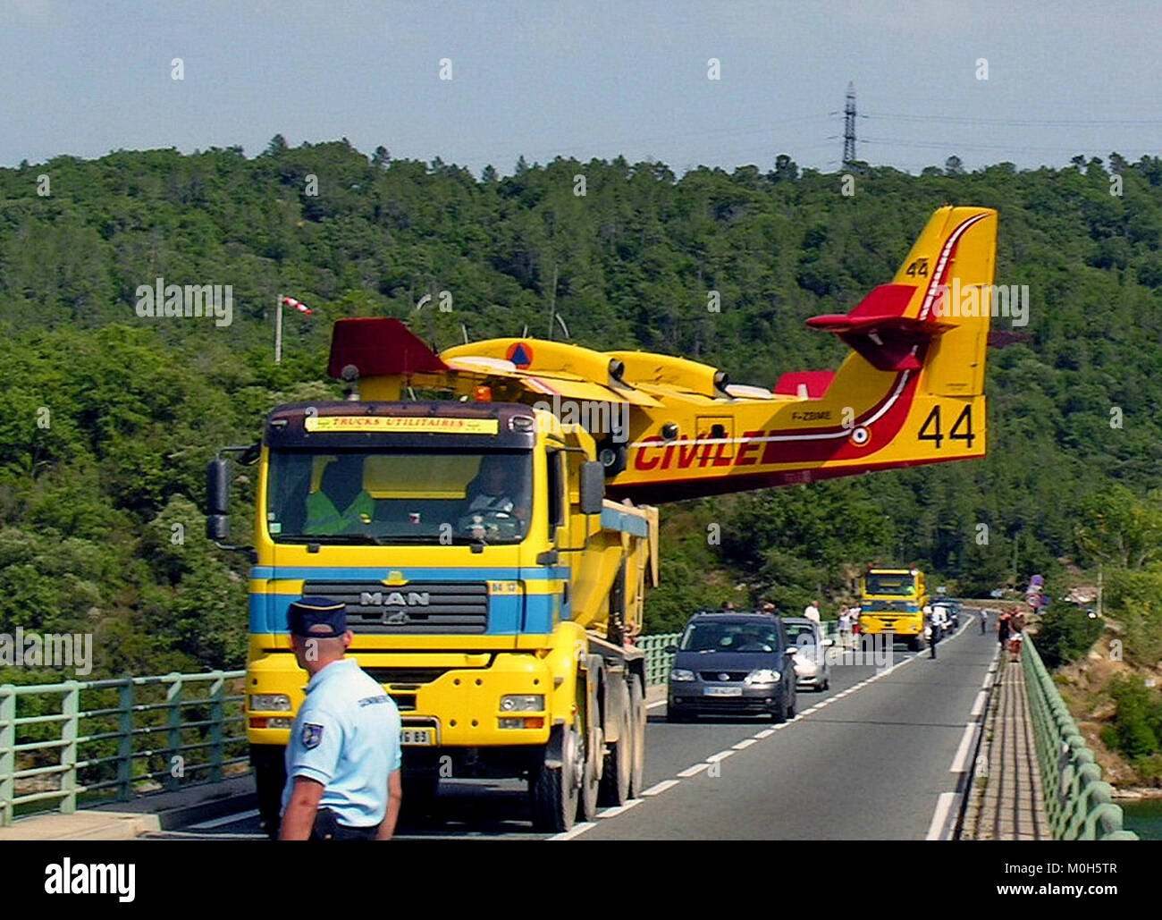 A photograph of the Canadair CL-44 aircraft over the Pré-Clau Bridge ...