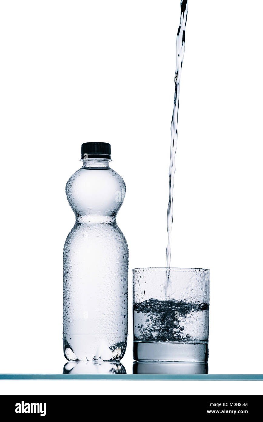 wet plastic bottle and water pouring into glass isolated on white Stock ...
