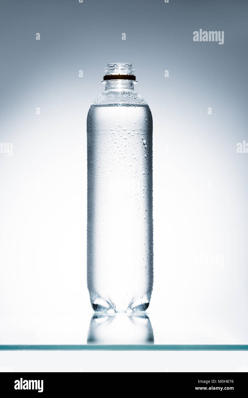 plastic bottle full of water on reflective surface Stock Photo - Alamy