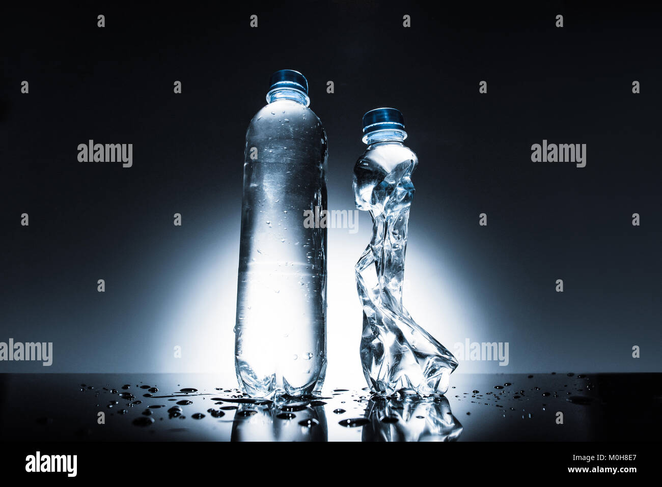untouched and crumpled bottles of water on dark Stock Photo - Alamy